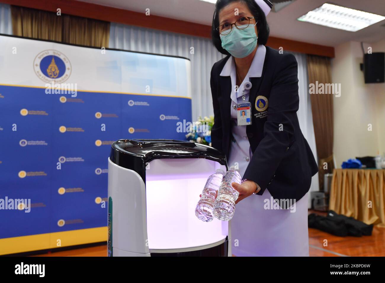 A nursing staff wearing face masks are experimenting with robot ...