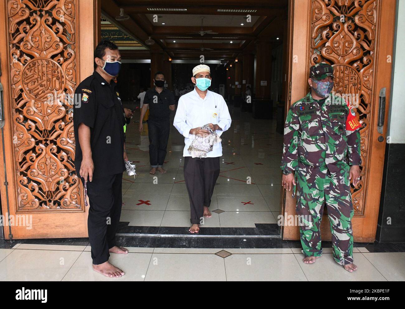 Muslims perform their first Friday prayer at the distance of the Al Barkah Great Mosque in ...