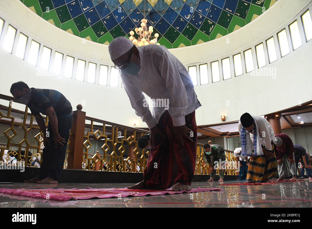 Muslims perform their first Friday prayer at the distance of the Al ...
