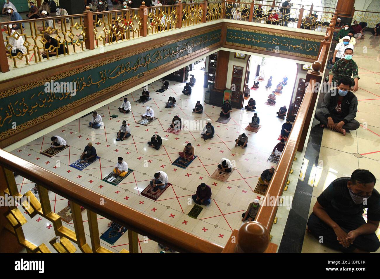 Muslims perform their first Friday prayer at the distance of the Al ...