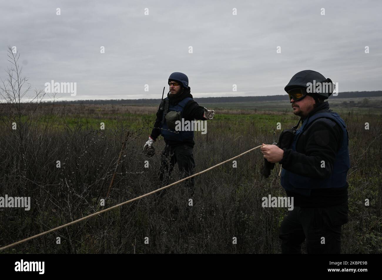 Ukrainian bomb disposal technicians prepare to safely move a landmine ...