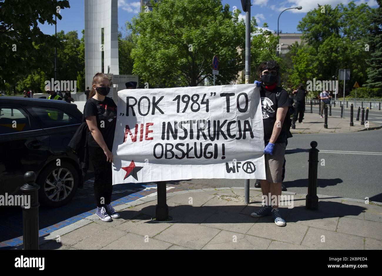 Demonstrators hold a banner that reads 1984 (Ninetteen eighty-four ...