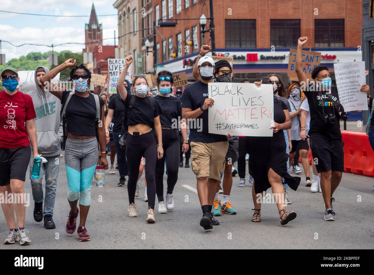 Demonstrators hold up signs during a Mass Action for Black Liberation ...