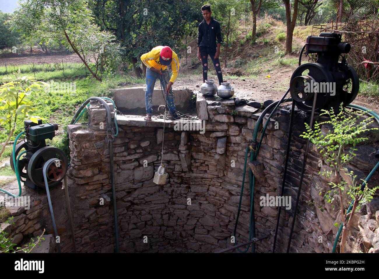 People fetch drinking water from a well During hot Summer Day on the ...