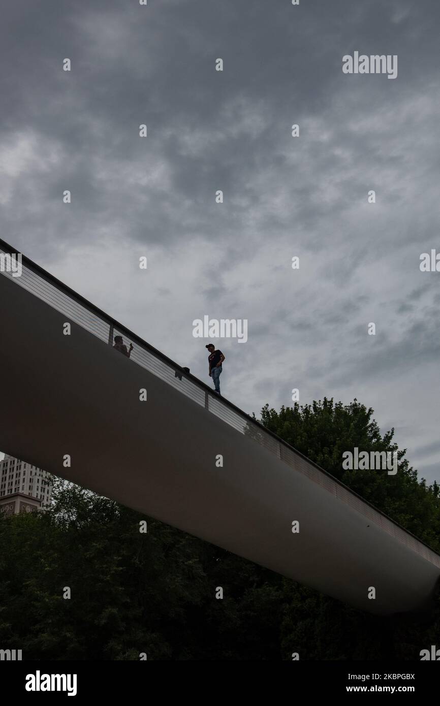 Bridge with man above the balustrade Stock Photo - Alamy