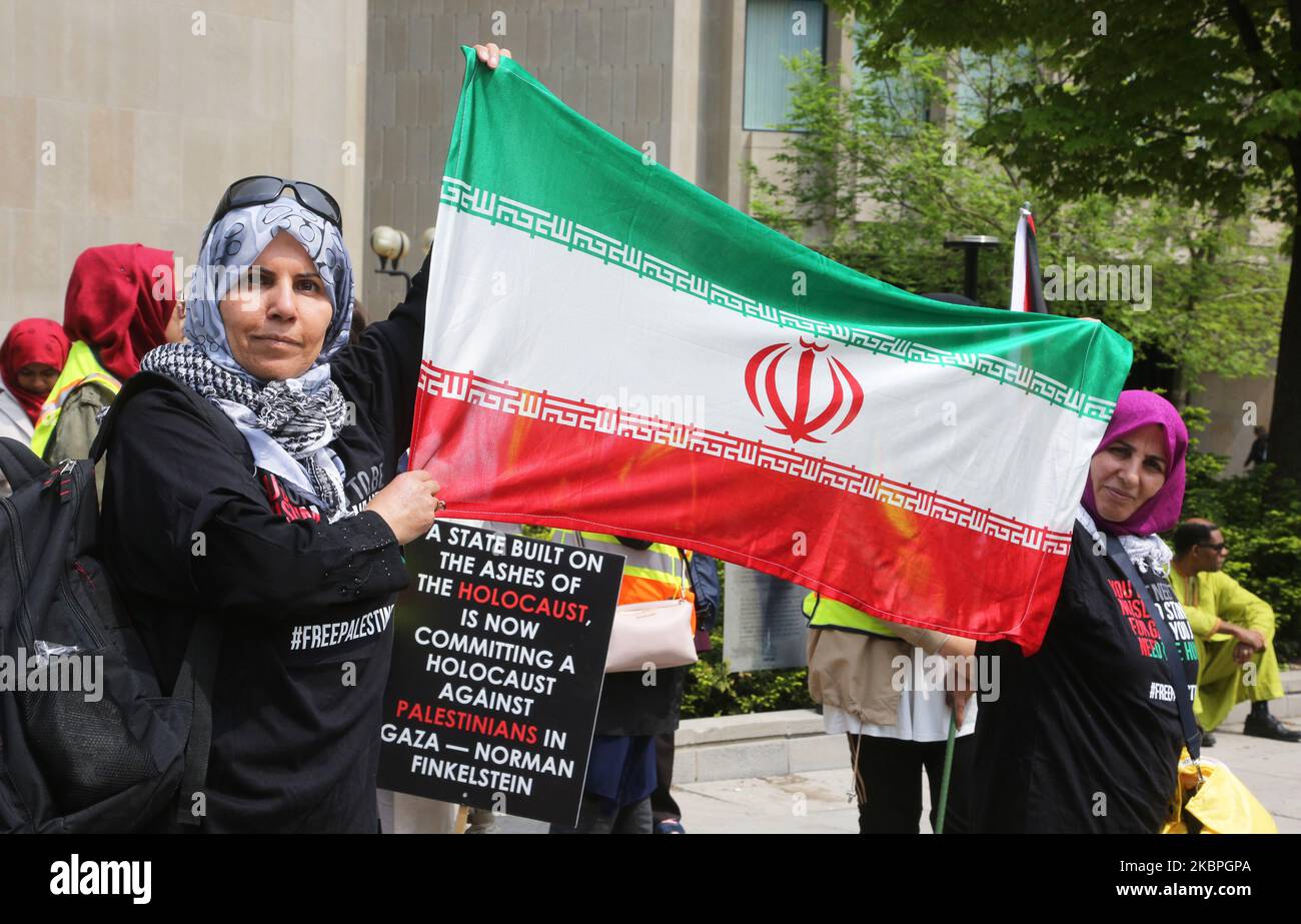 Women hold an Iranian flag during the Al Quds Day (Al-Quds Day) rally ...