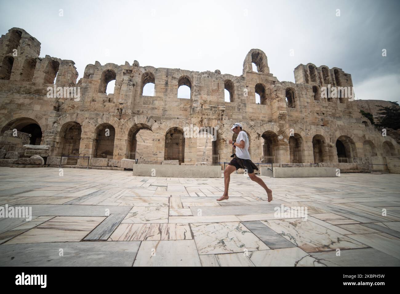 A runner in front of the Odeon of Herodes Atticus (Photo by Maria ...