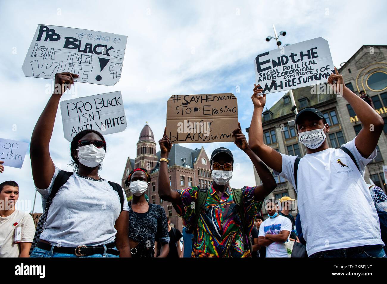 A group of Black people are holding placards during the massive ...