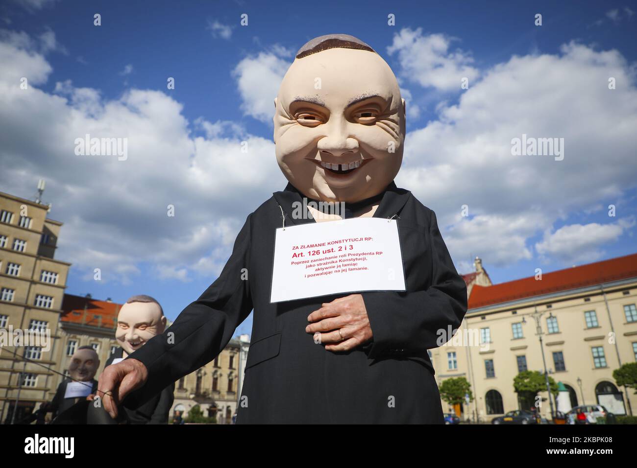 People wearing masks with a face of Andrzej Duda, the President of ...
