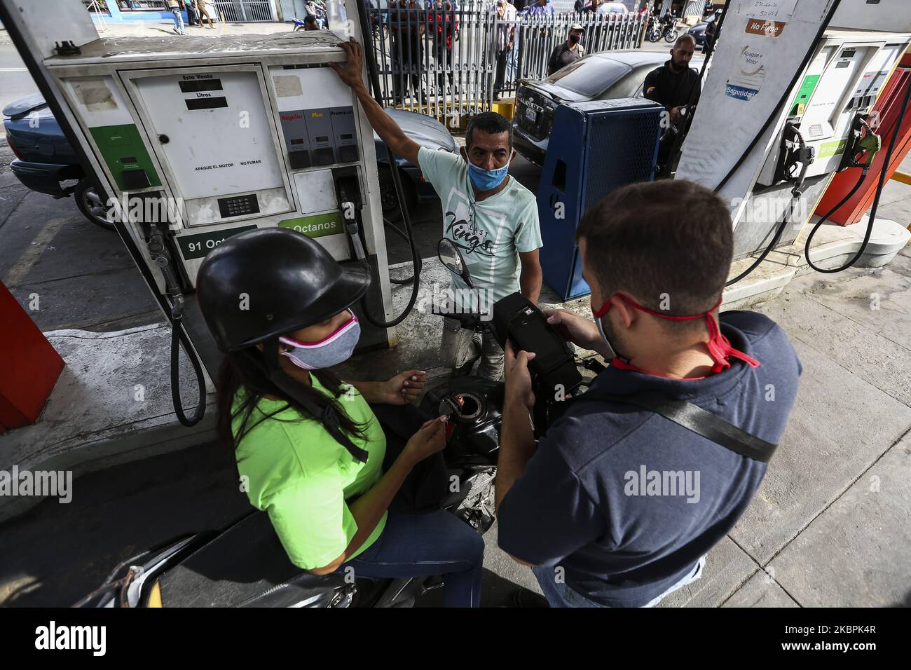 People queue for fuel at a gas station after Venezuela's government ...