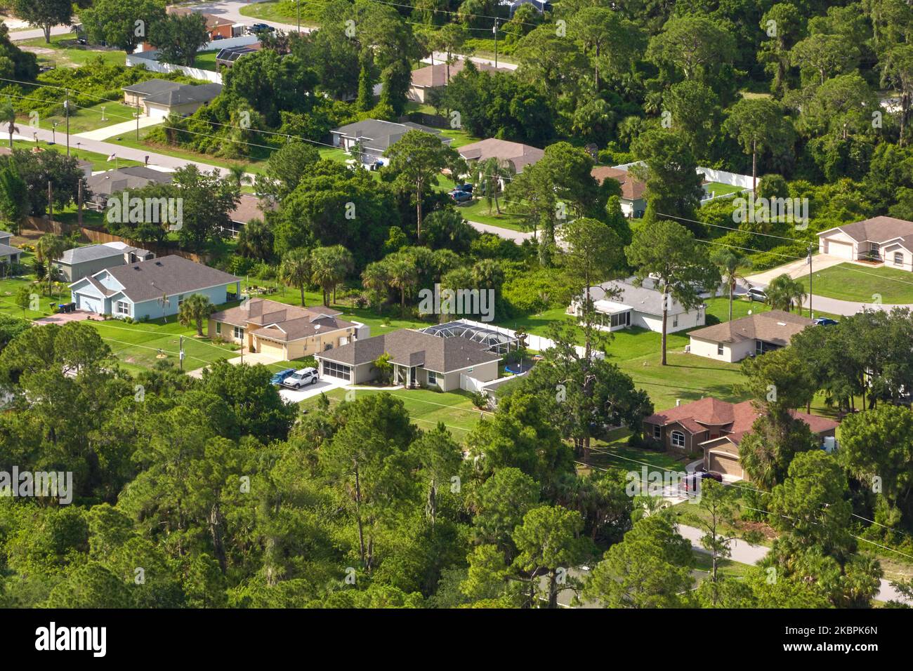 Aerial landscape view of suburban private houses between green palm ...
