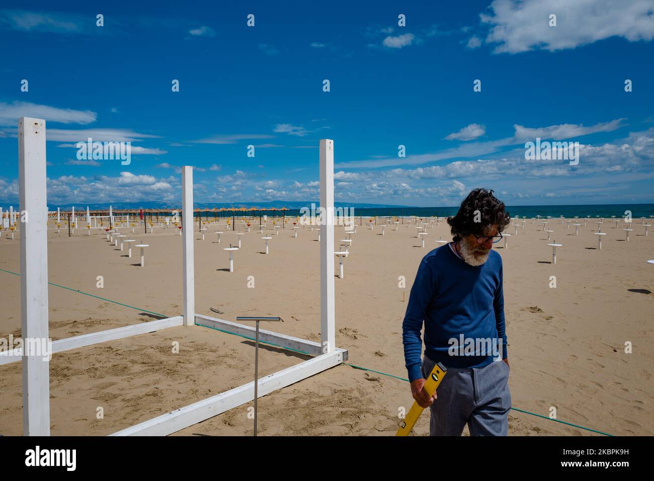 The owner of the bathing structure at work on the beach of Margherita ...