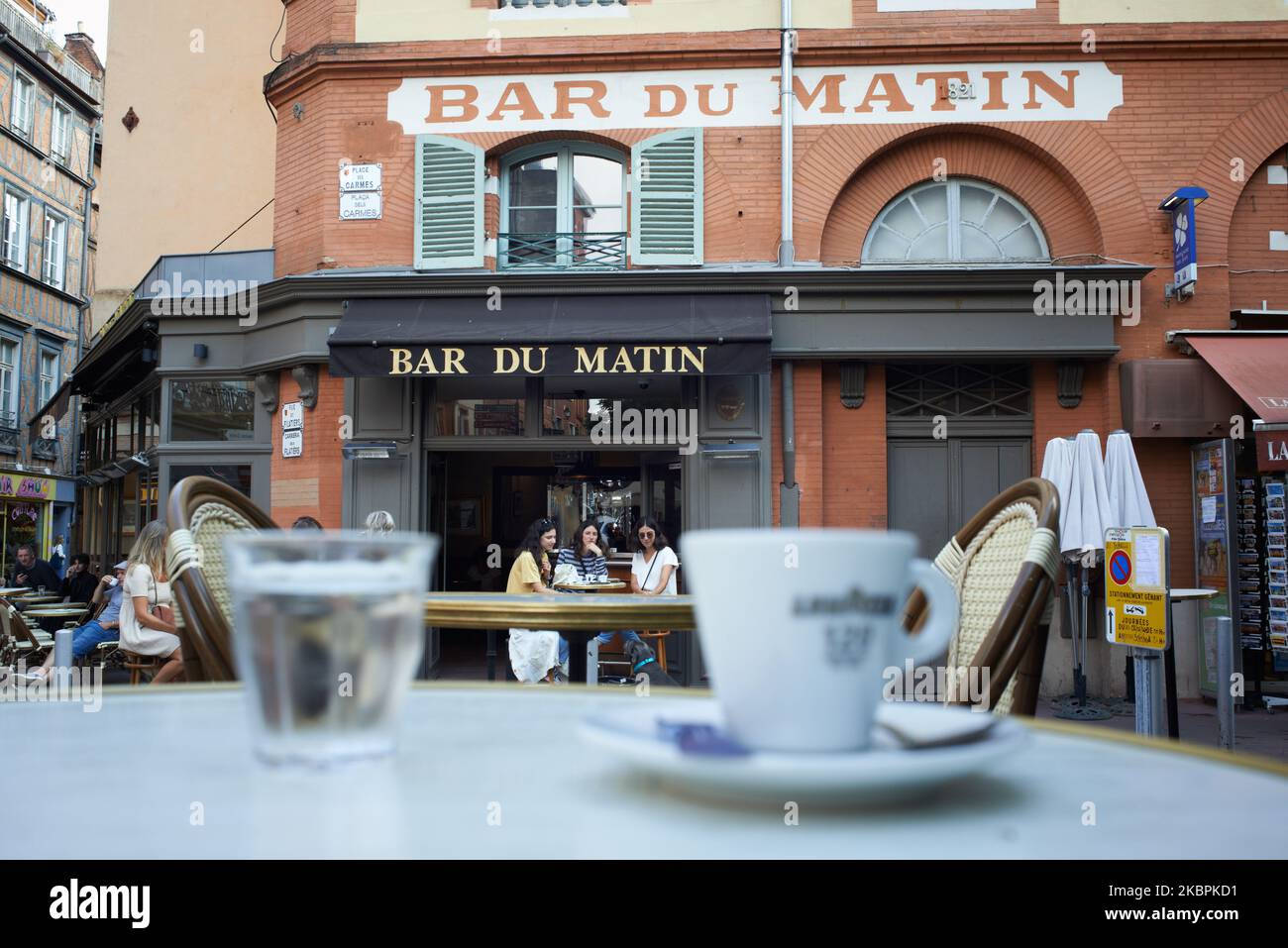 People enjoy thier first coffee on a cafe's terrace. This one is called ...