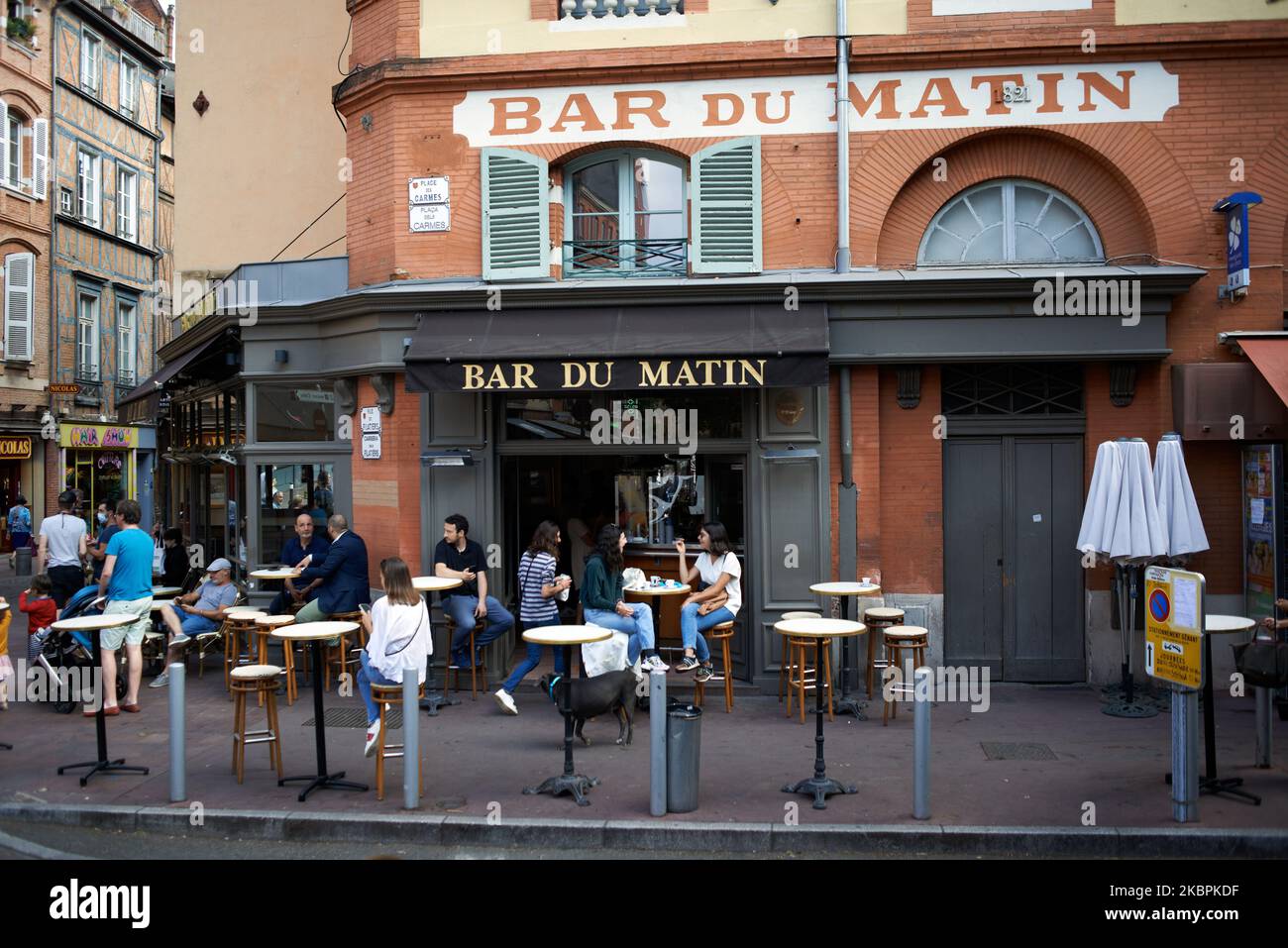 People enjoy their first coffee on a cafe's terrace. This one is called ...