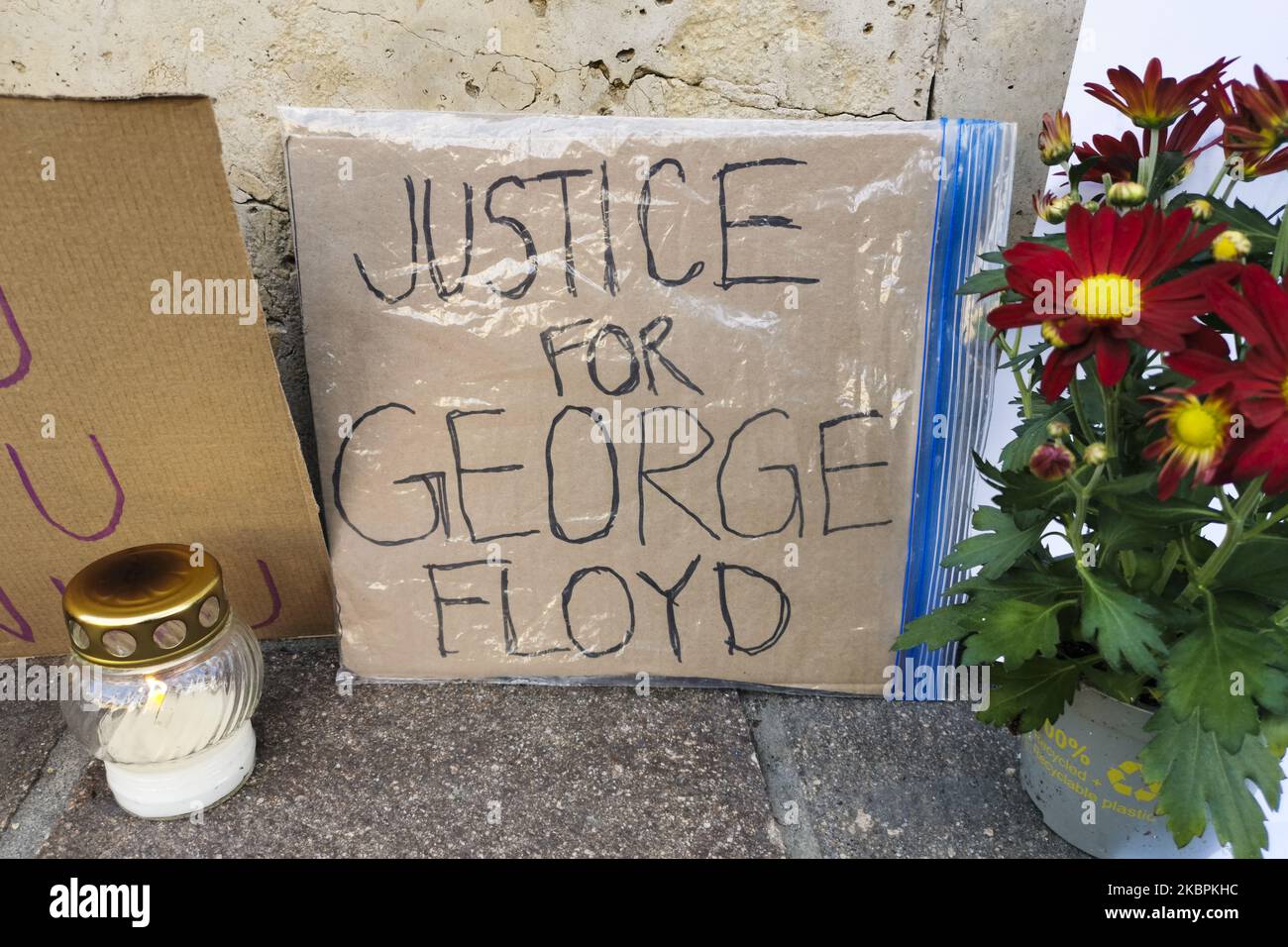 Candles and flowers are laid in front of the U.S. Consulate General as ...