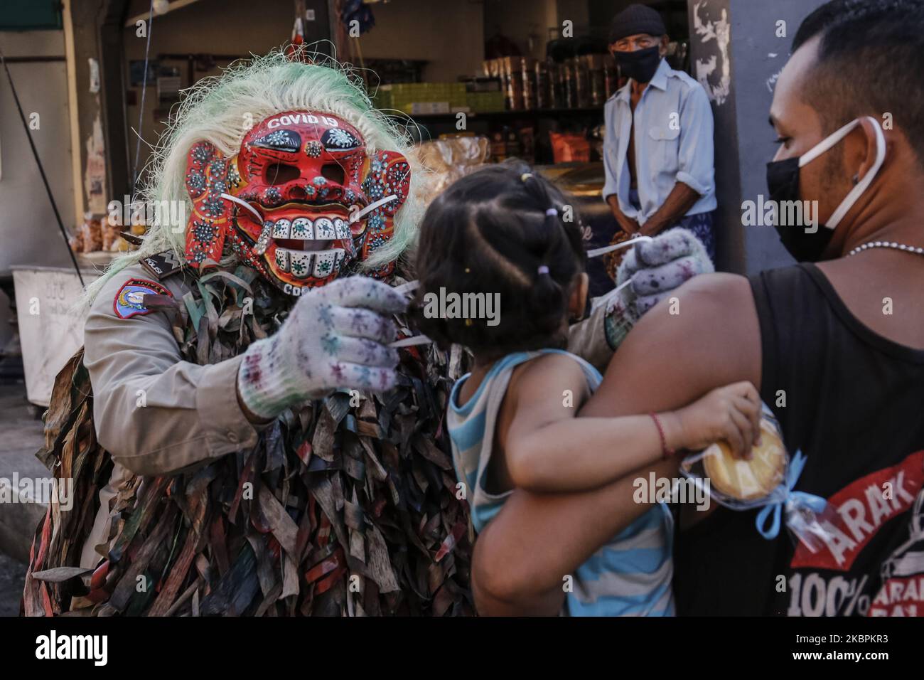 Police officer wears modified Balinese traditional scary mask, locally ...