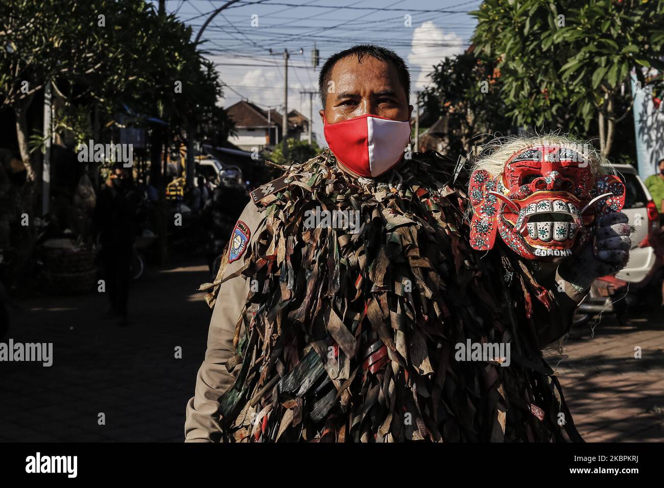 Police officer prepares to wear modified Balinese traditional scary ...
