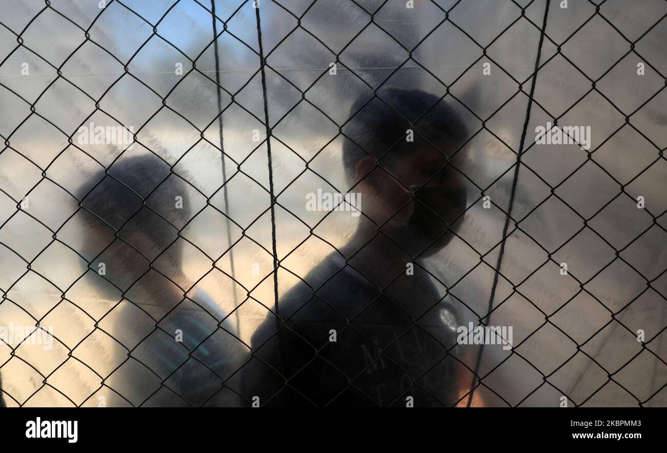 People leave after performing the Dhuhr (noon) prayers at mosque, in ...