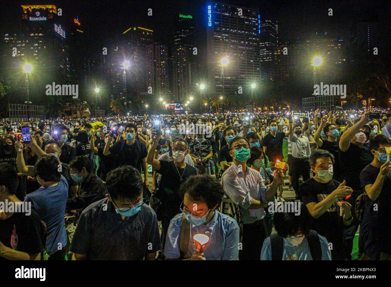 At 20:09 local time, residents held up candles and mobile phones in ...