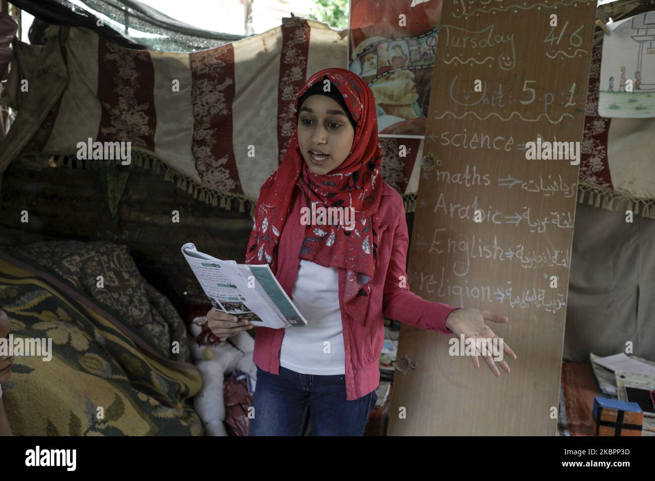 A Palestinian school girl Fajr Hmaid, 13, teaches her neighbours ...