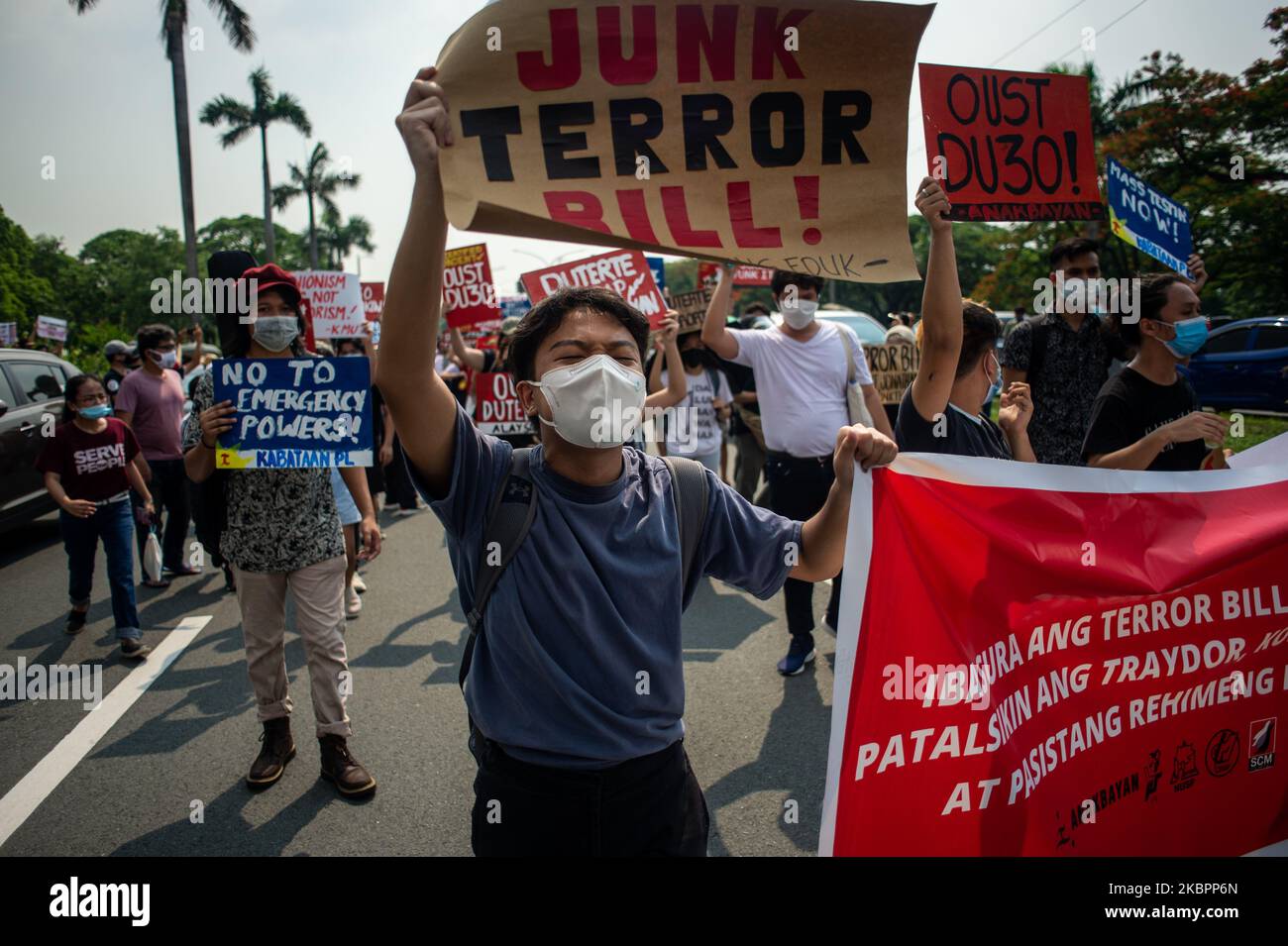 A man carrying a placard which reads "Junk Terror Bill" joins a rally ...