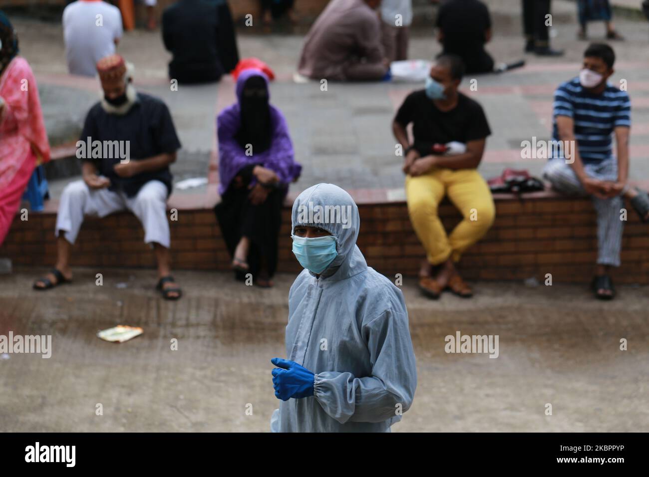 People gather outside of the Mugda Medical College and Hospital to get ...