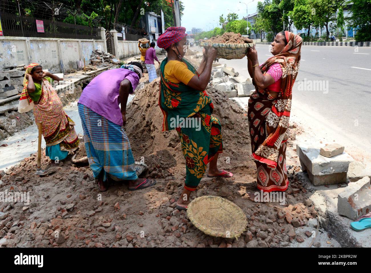 Bangladeshi Daily Labor works without facemask at a road construction ...