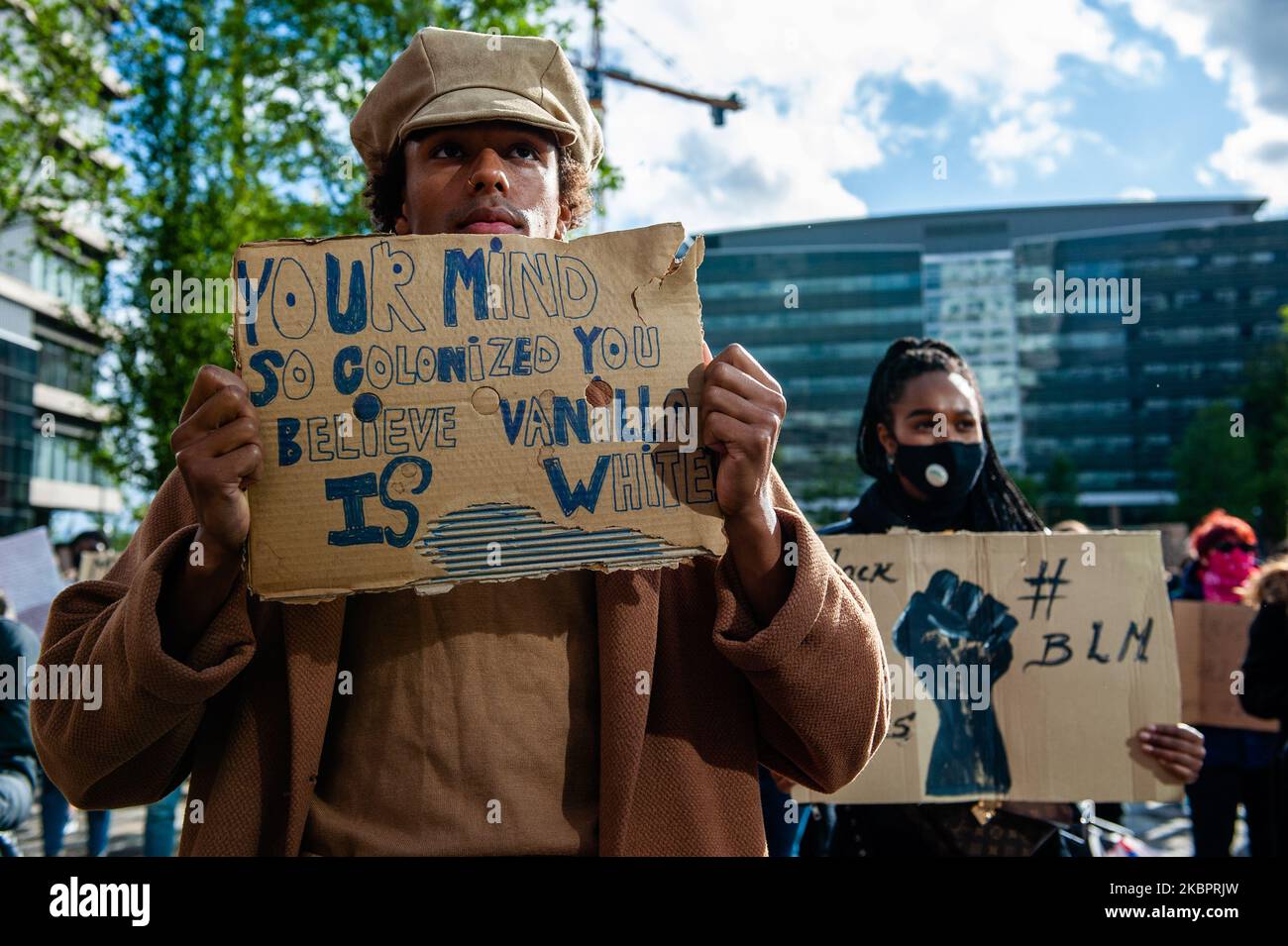 A man is holding an anti racist placard, during the massive solidarity ...