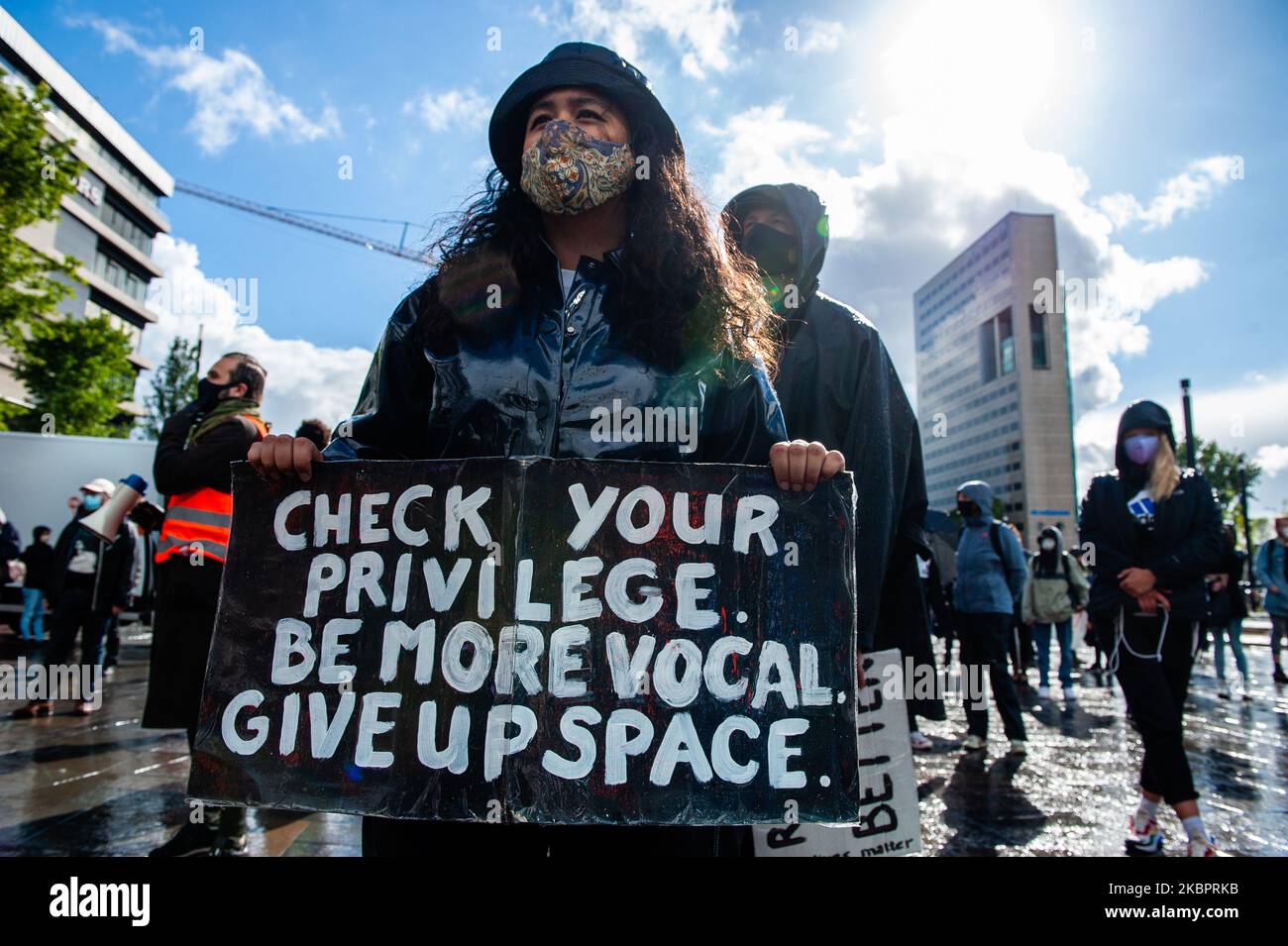 A woman is holding an anti racist placard, during the massive ...