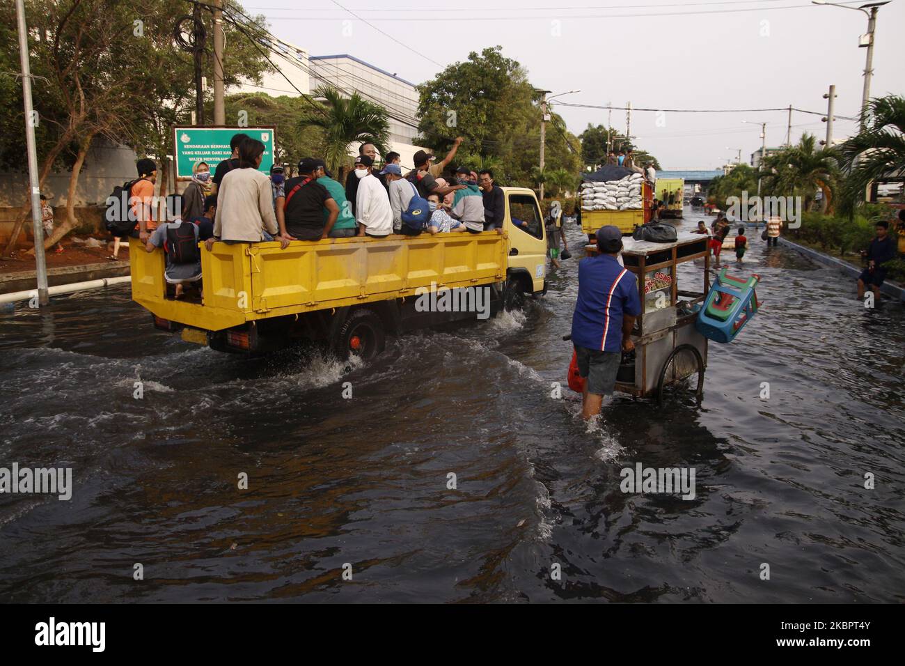 Residents ride in trucks to crossing the flood water cause by rob as ...