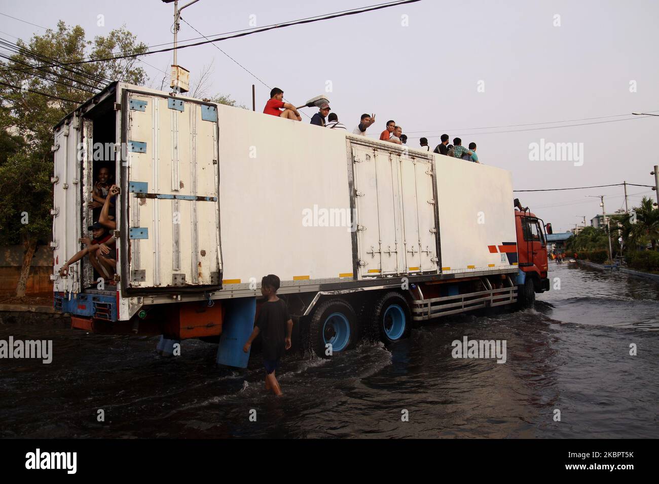 Residents ride in trucks to crossing the flood water cause by rob as ...