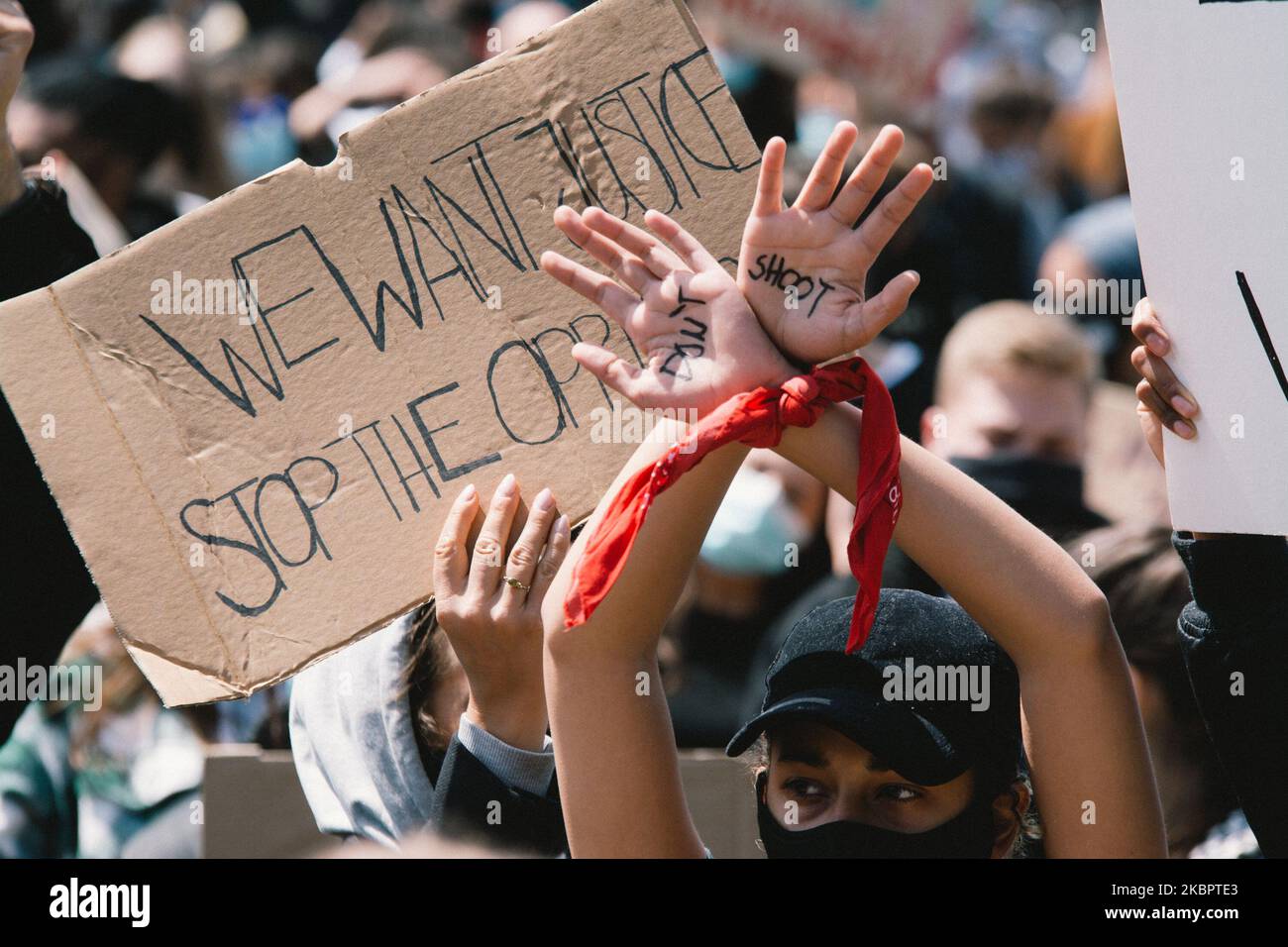 '' Don't shoot'' written on the hand is seen with the ''We want justice ...