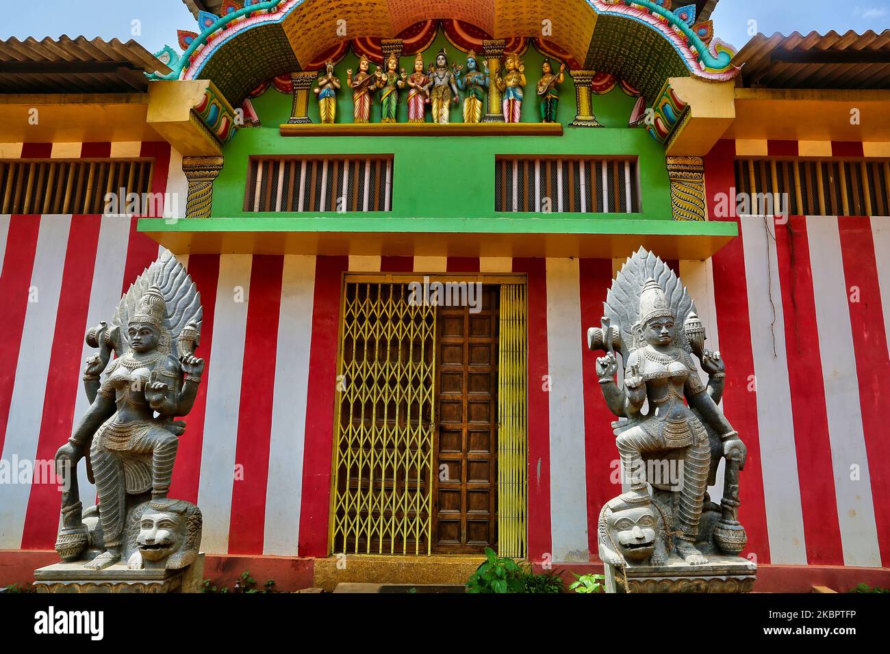 Statues of female guardian deities flanking the entrance of the Arul ...