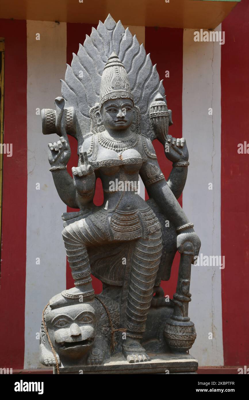 Statue of a female guardian deity flanking the entrance of the Arul ...
