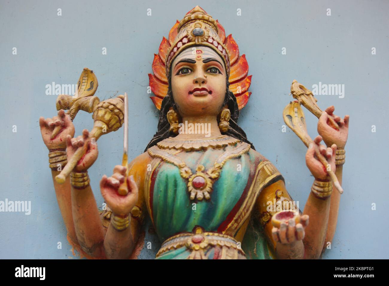 Statue of a female guardian deity flanking the entrance of the Arul ...