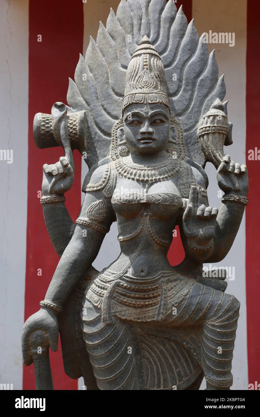 Statue of a female guardian deity flanking the entrance of the Arul ...