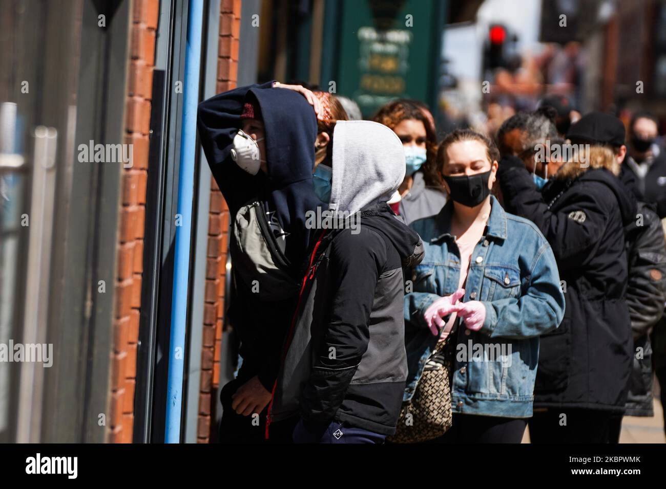 Shoppers observe social distancing as they wait to enter a Subway fast ...