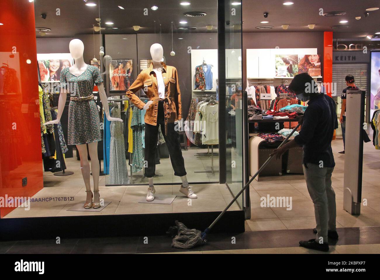 A worker clean the World Trade Park mall ahead of its reopening, during ...