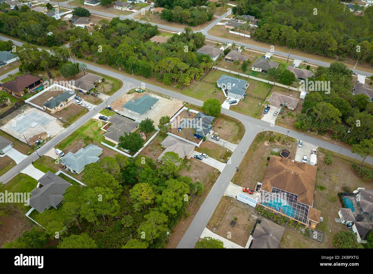 Aerial landscape view of suburban private houses between green palm ...