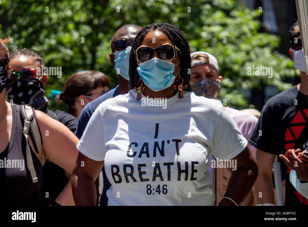 A woman listens to activist Iris Roley speak during today’s protest ...