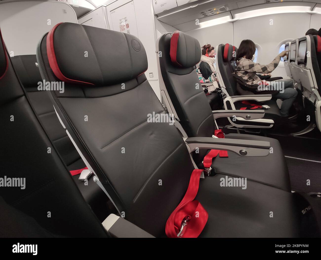 Passengers wearing protective face masks during a flight. Flying with ...