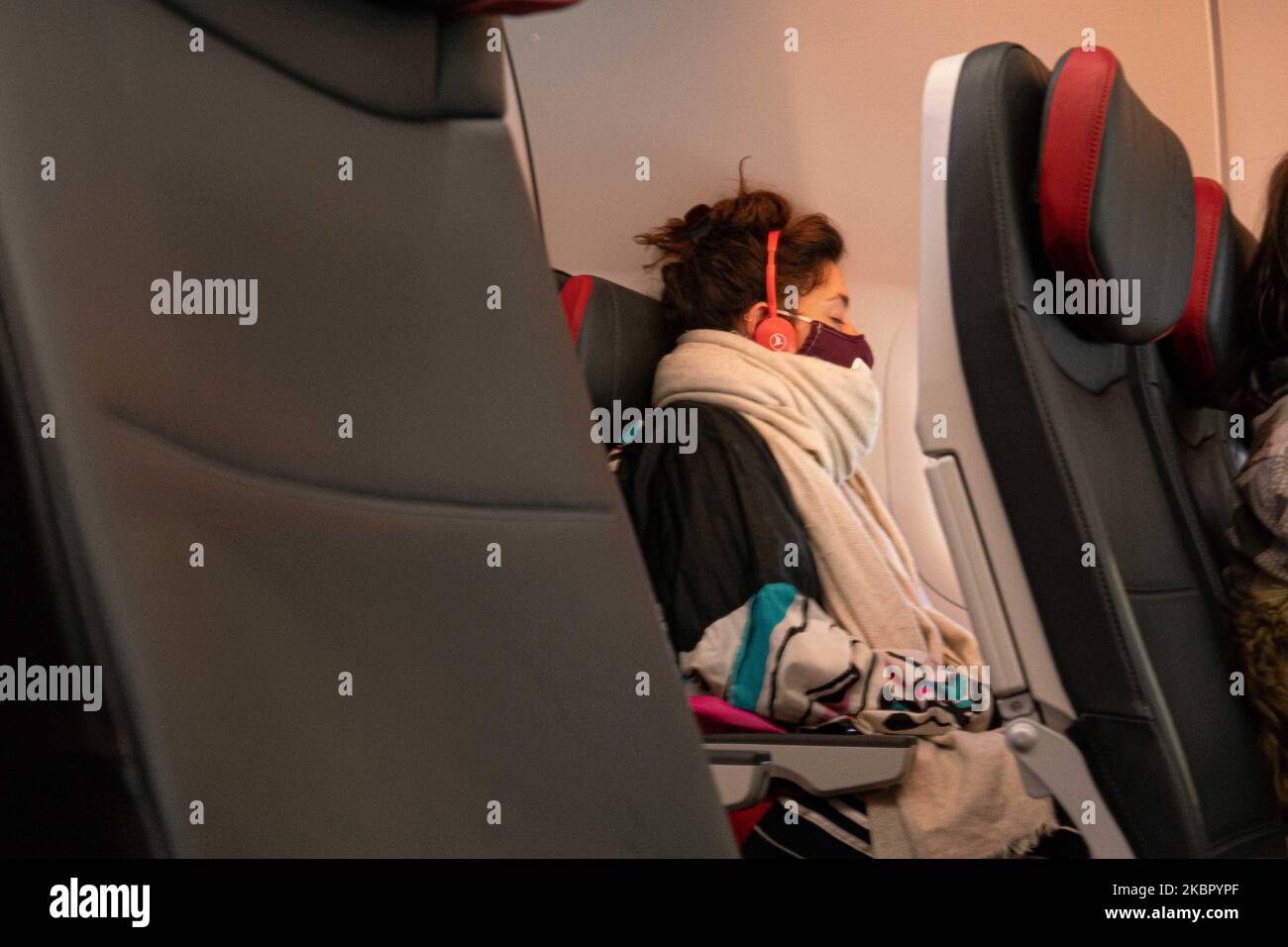 Passengers wearing protective face masks during a flight. Flying with ...