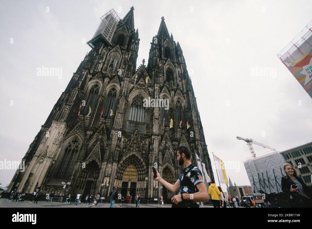 a tourist takes selfie in front of Dom Cathedral in Cologne. Cologne's ...