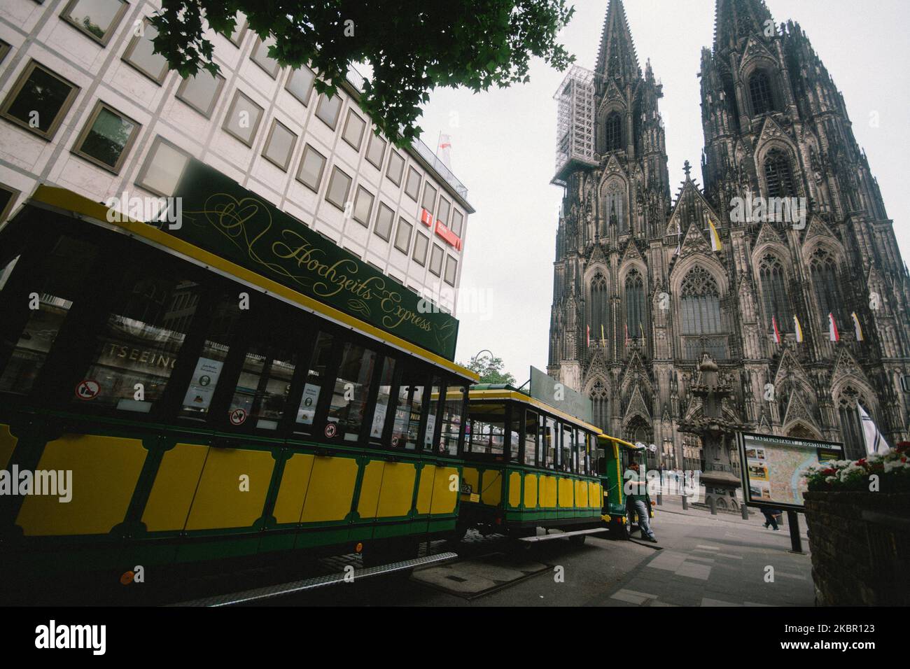 a tourist bus parks in front of Dom Cathedral. Cologne's tourism ...