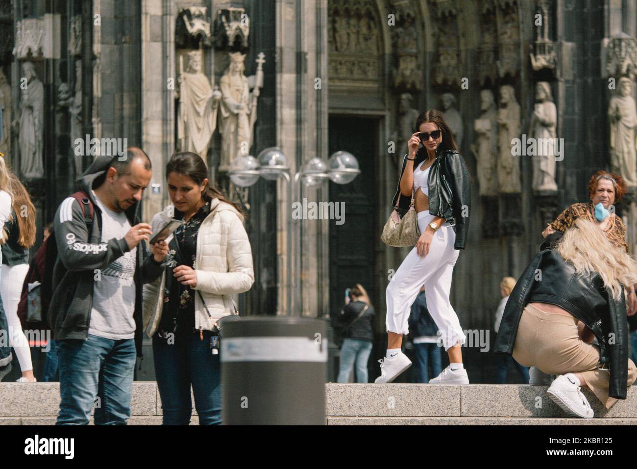 tourists take pictures in front of Dom Cathedral. Cologne's tourism ...