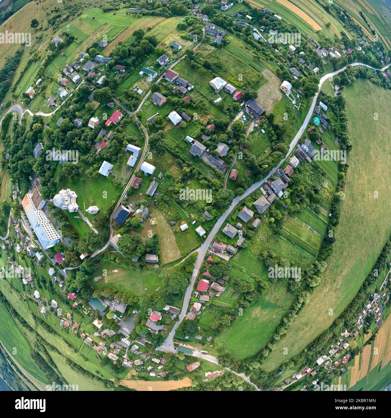 Aerial landscape view of village houses and distant green cultivated ...