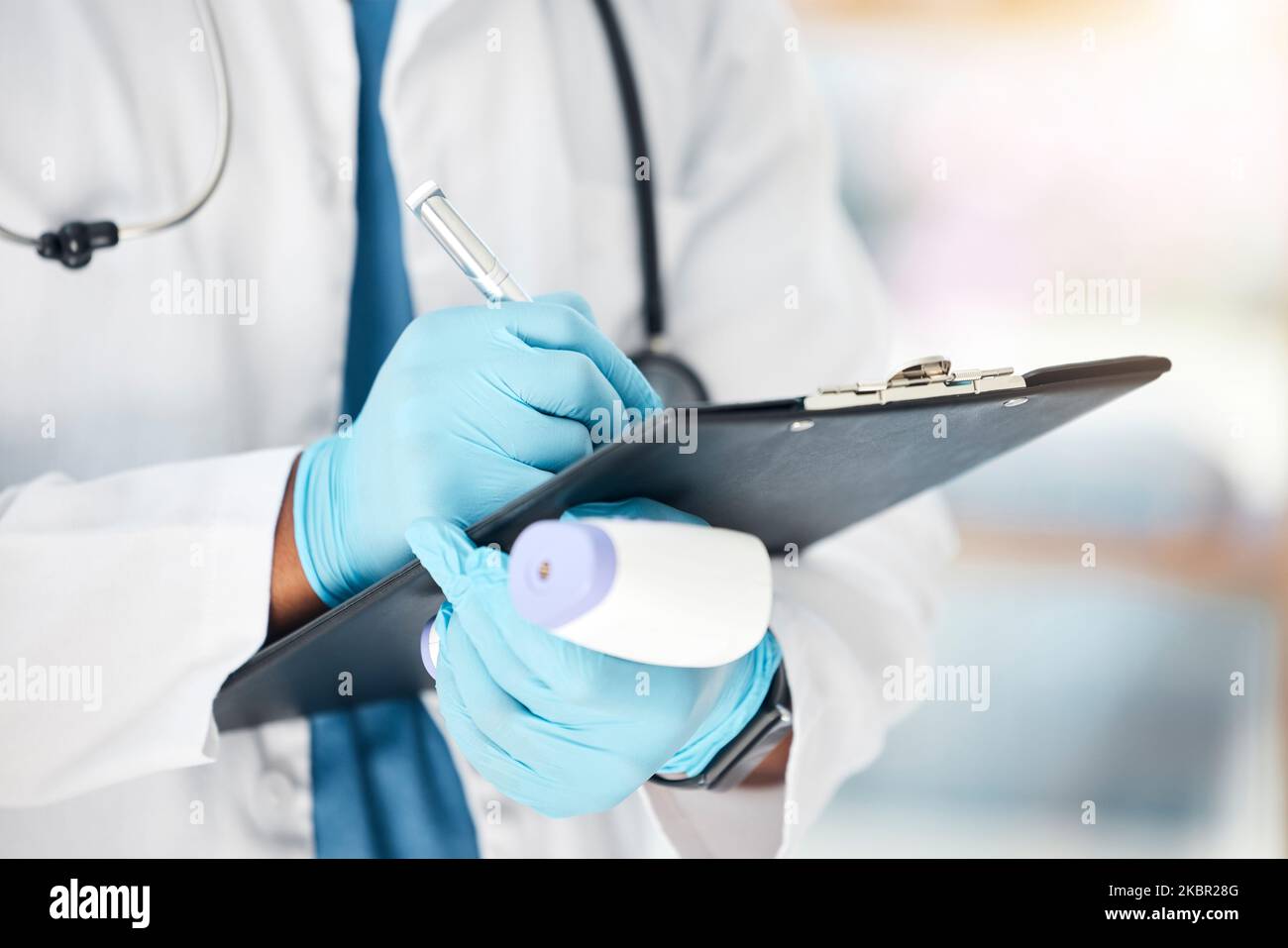 Covid doctor, thermometer and writing notes, information and healthcare ...