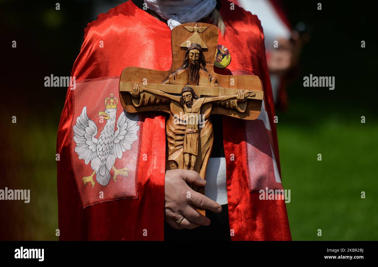 A member of the Order of Knights of Christ the King carries a wooden ...