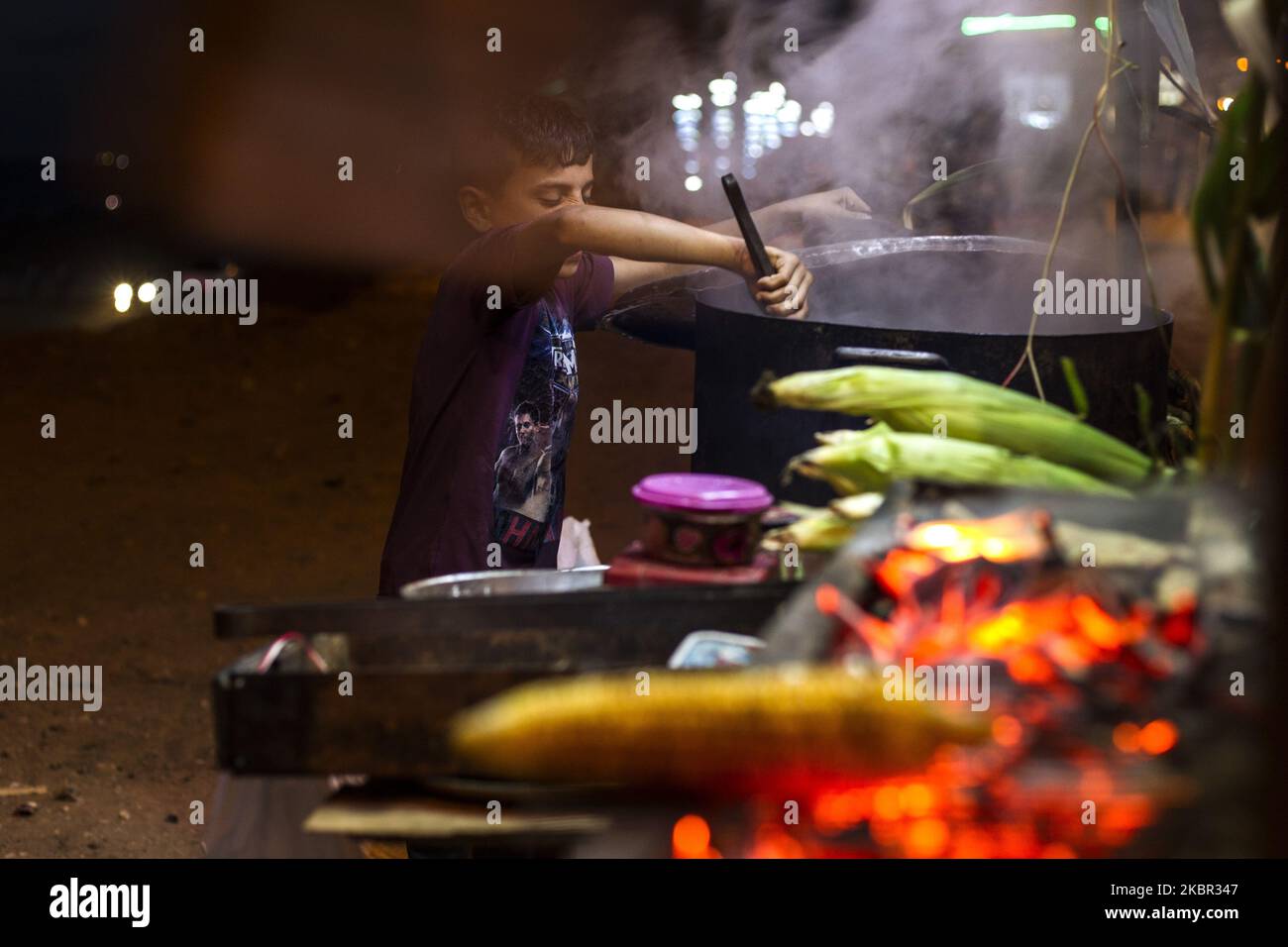 A Palestinian boy Mohammed Naser 10 years old, sells corn at Gaza Beach ...