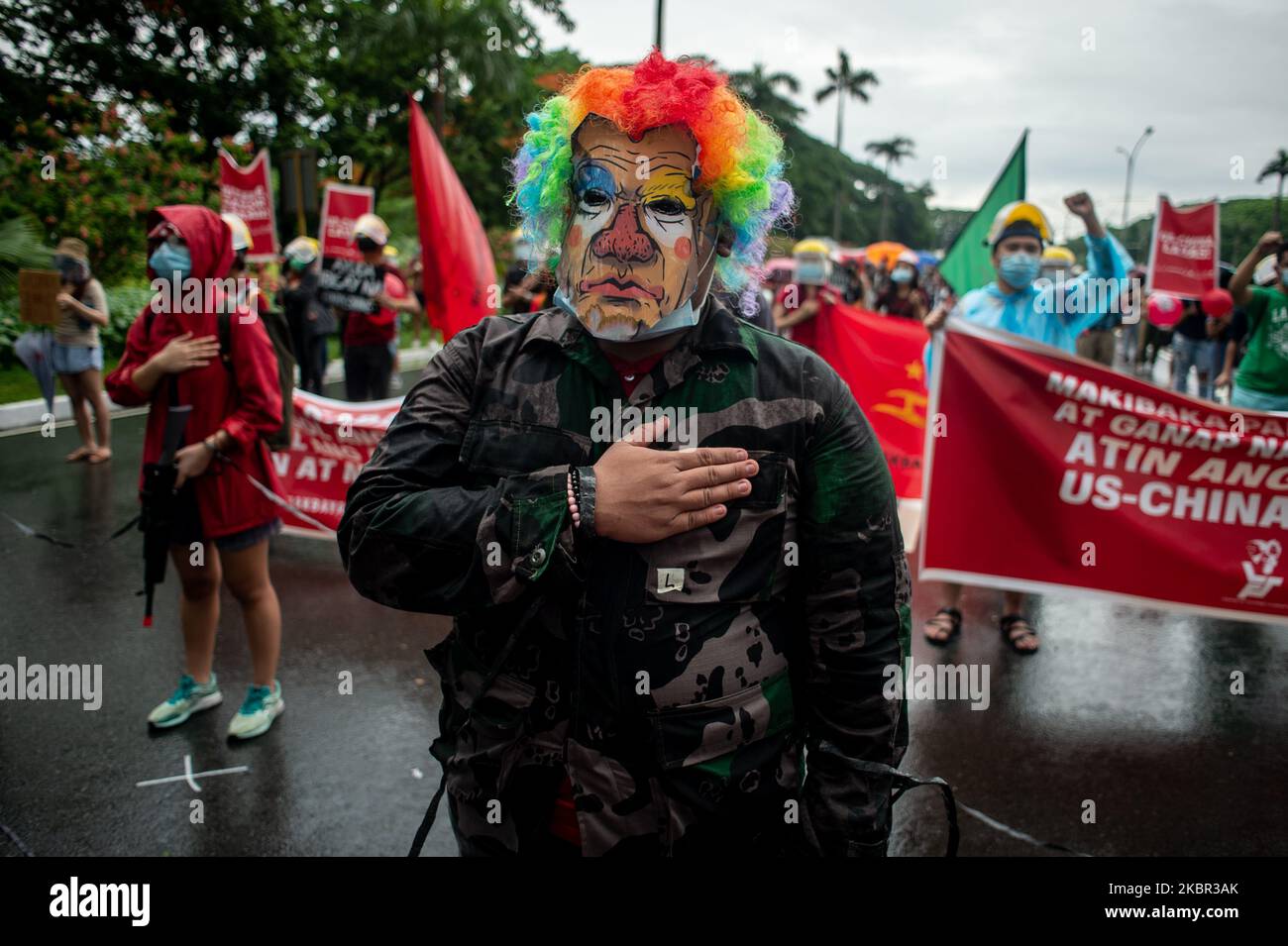 A man depicting Philippine President Rodrigo Duterte as a clown sings ...